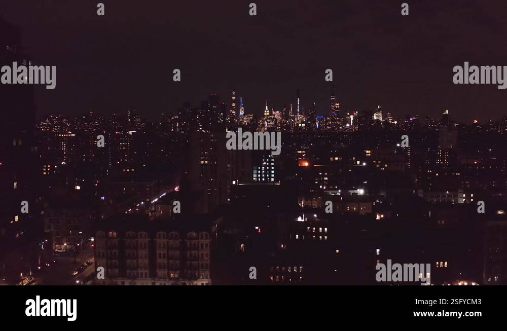 floating aerial pan over the Harlem neighborhood of NYC at night ...