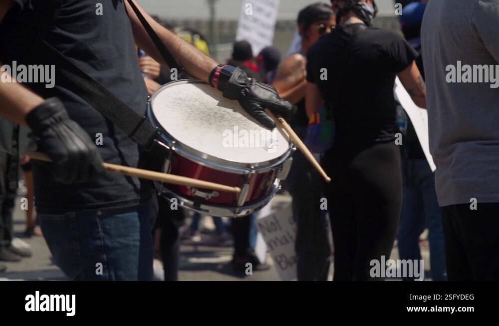 A Man taps his drum at a BLM protest outside City Hall. Slow Motion ...