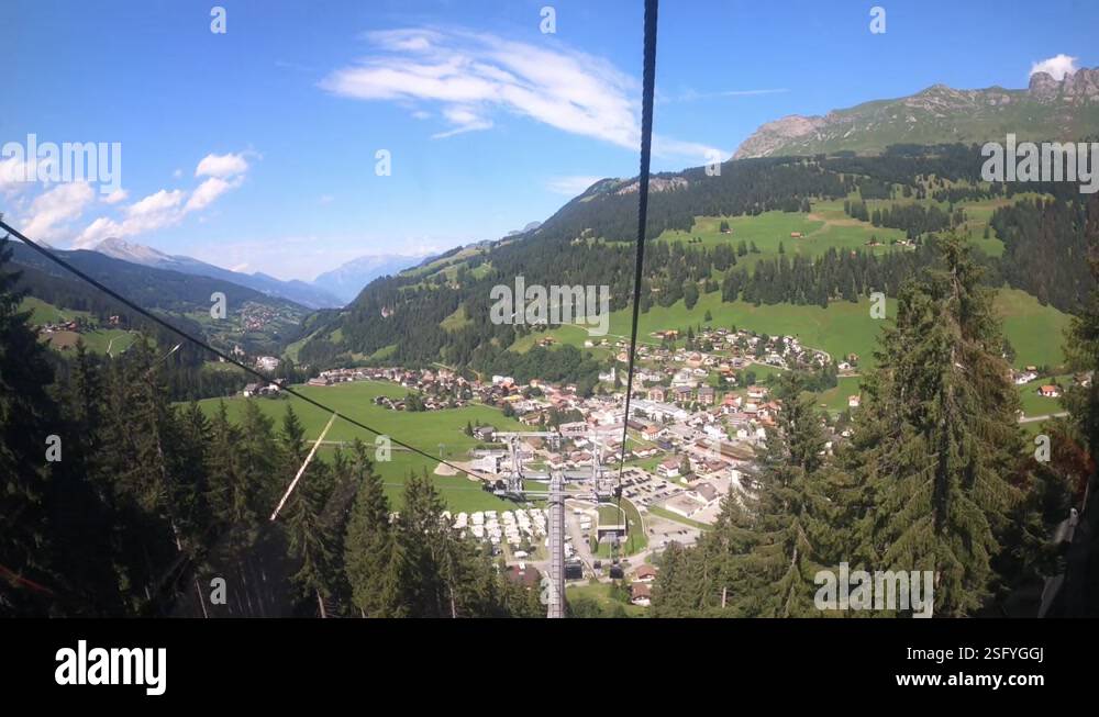 Cable car ride in Switzerland. The cable car descends into the valley ...
