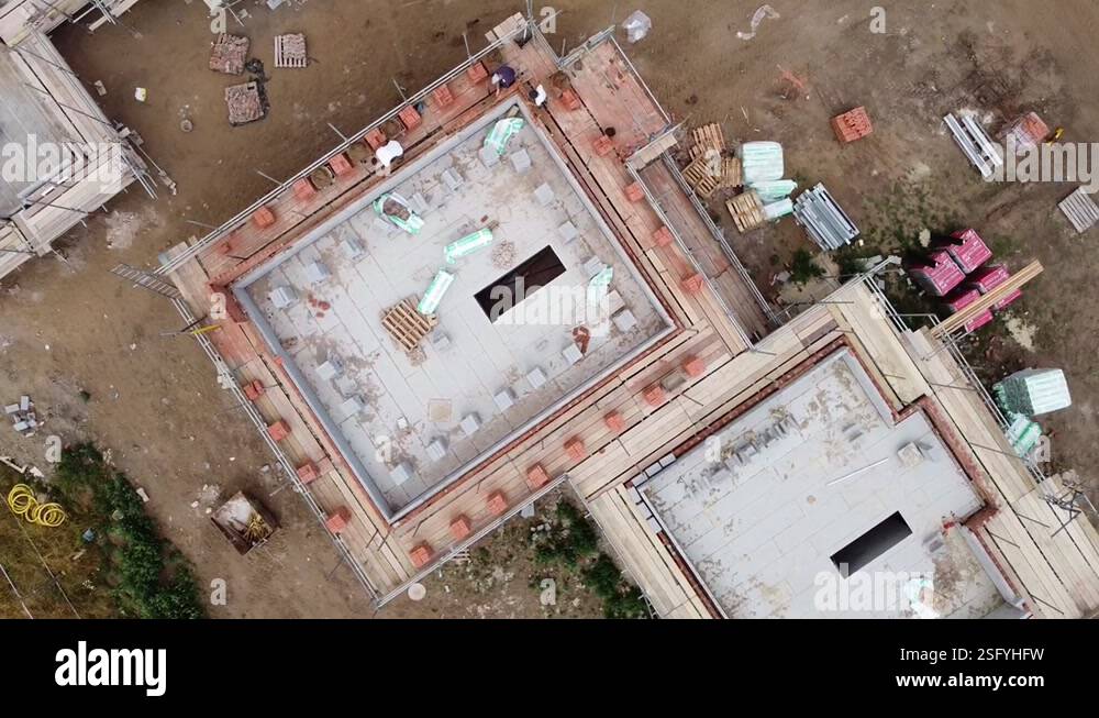 Rotating ascending aerial view of bricks being laid on a new build ...