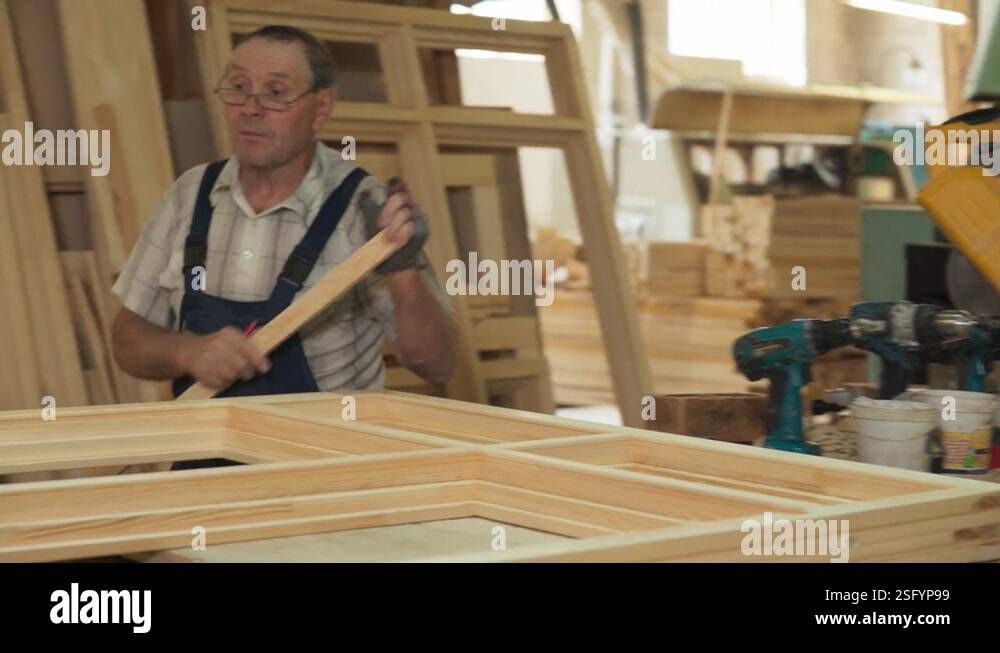 Carpenter Makes Wood Planks For Window Frame Assembly With Saw ...