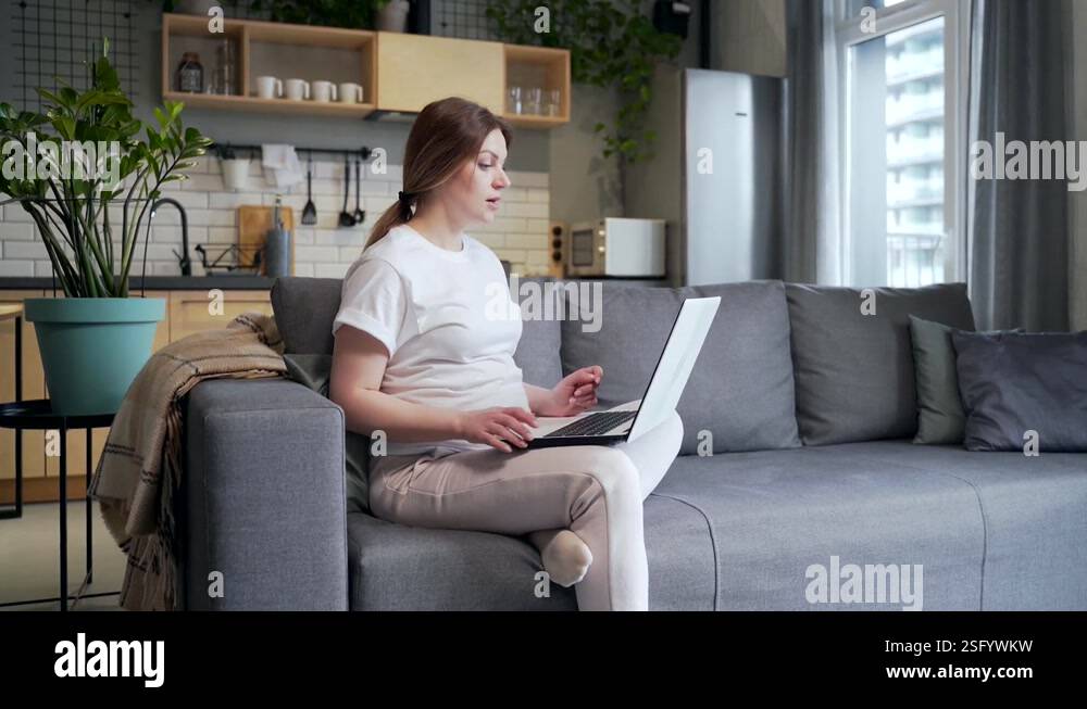 young pregnant business woman works remotely make a meeting, conference ...