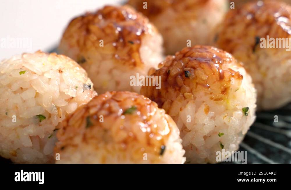 Brush sweet soy yaki sauce and mayonnaise on small round rice ball in ...