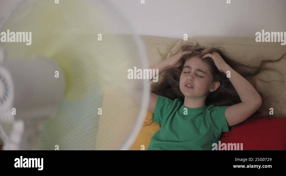 Girl Sitting on Sofa of Fan Hot Day Child Enjoying Cool Wind From ...