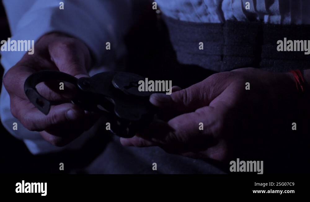 Houdini practices a handcuffs magic trick with his hands, Actor ...