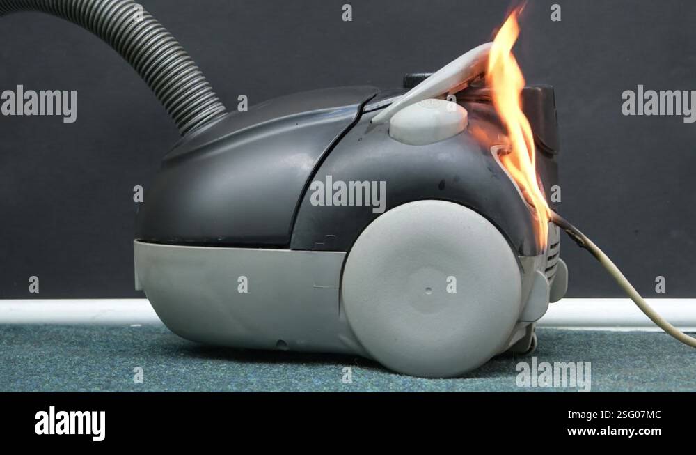 The fire burns in the vacuum cleaner, sparks fly, the plastic case ...