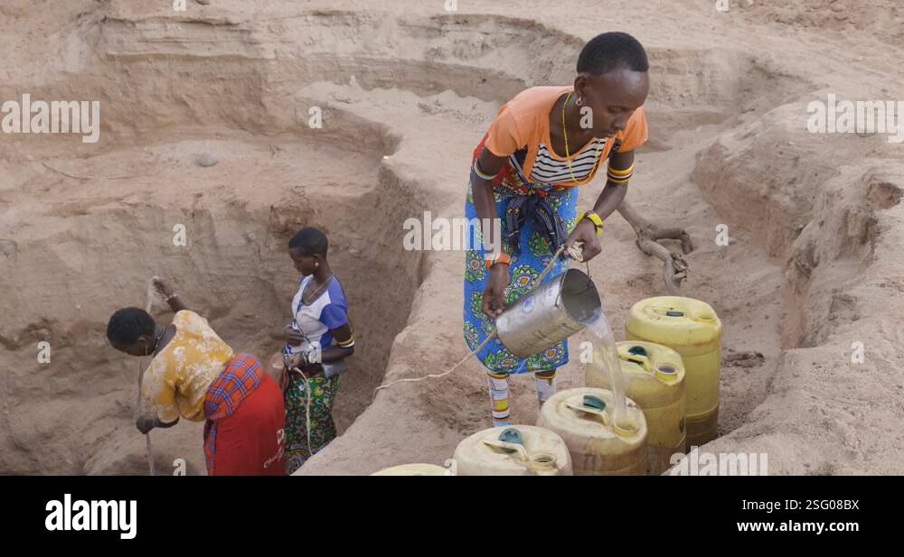 Climate change.drought. aerial view.African woman getting water from ...