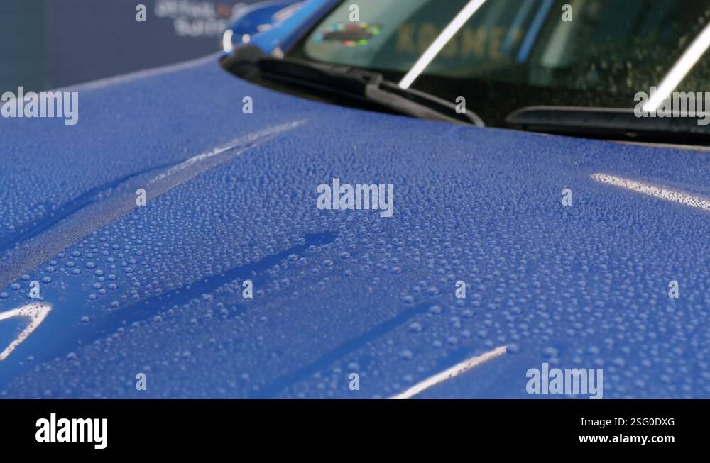 Close up showing hydrophobicity effect using shiny new lacquer on hood ...