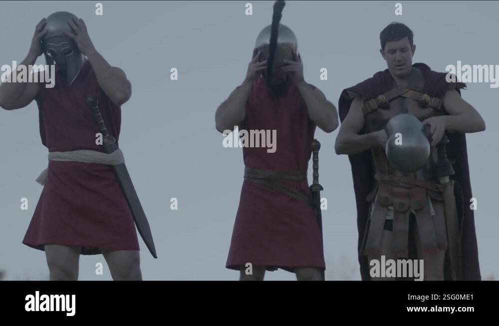 Ancient Greek Spartans in helmets and armor fight with swords ...