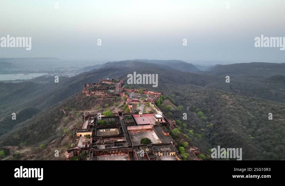 Aerial Forward Shot Of Old Fort On Natural Mountain In City Against ...