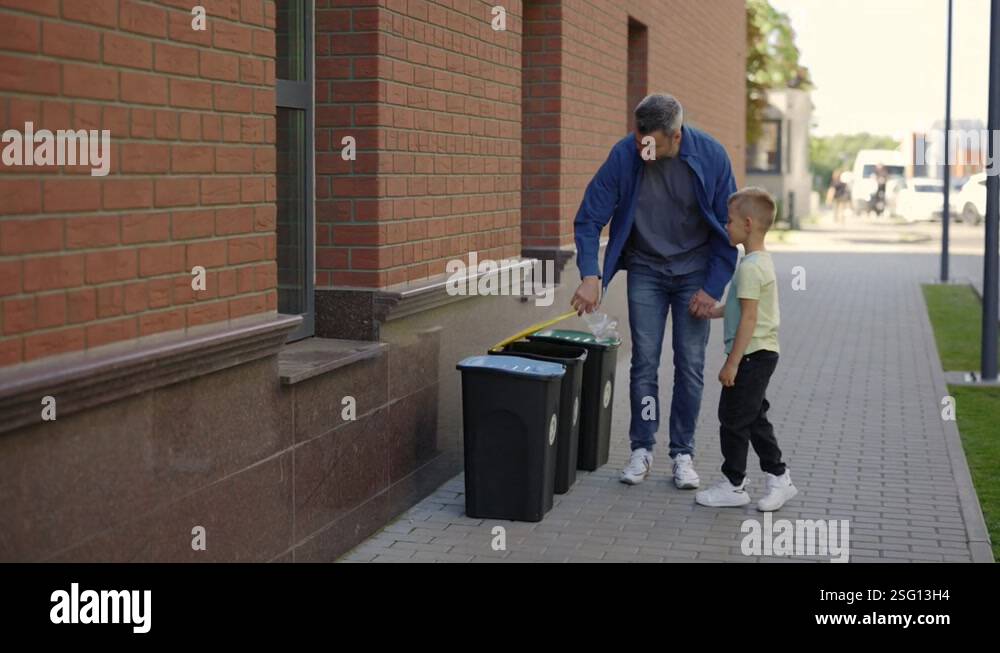 Dad teaches his son to properly sort garbage. Father and son sorting ...