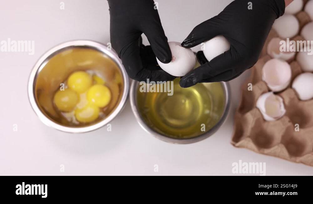 Separating yolk and white of the white raw shell egg with hands in ...