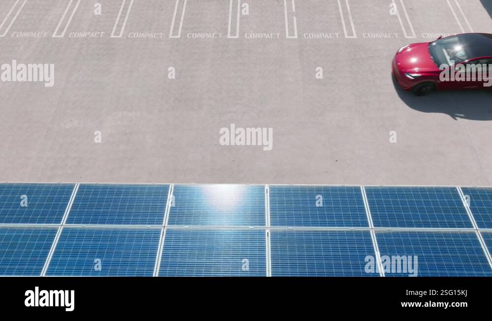 Aerial view red car parking under solar panels, 4K electric zero ...
