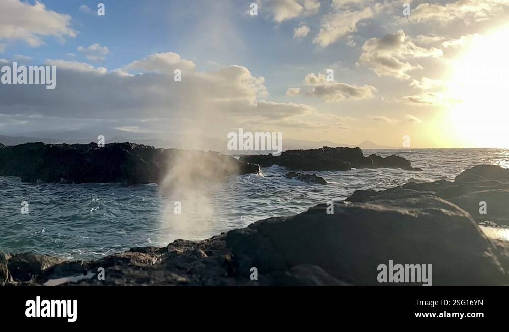 natural siphon in a rocky volcanic beach in El Confital beach during ...