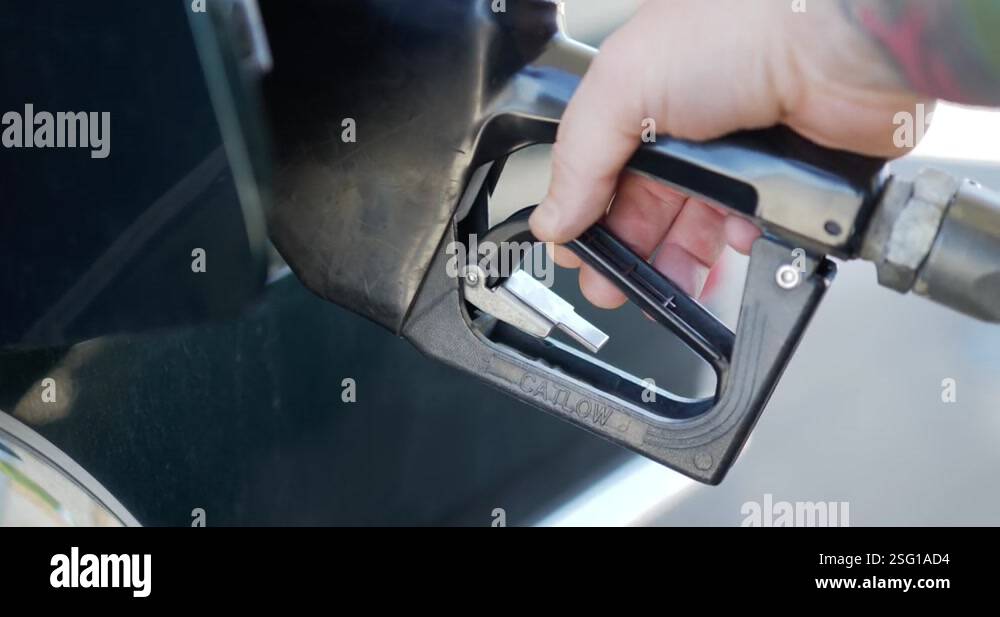 Gas Station Pump Handle being depressed then removed from green car ...