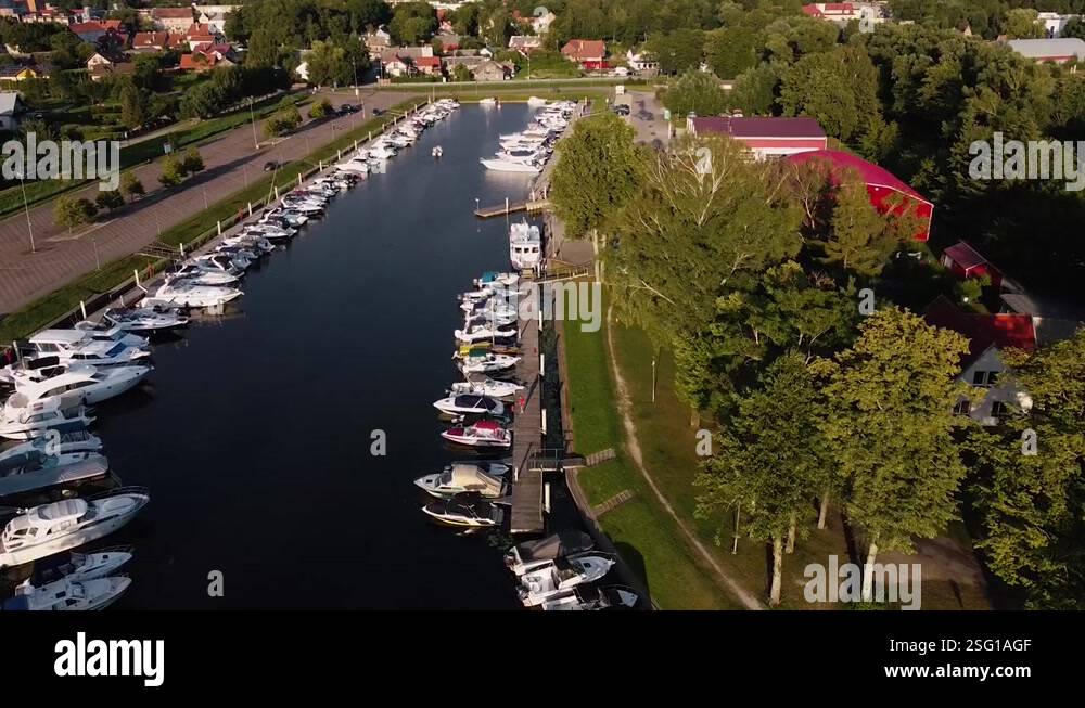 Arial right to left pan and motion shot of a small Marina with private ...