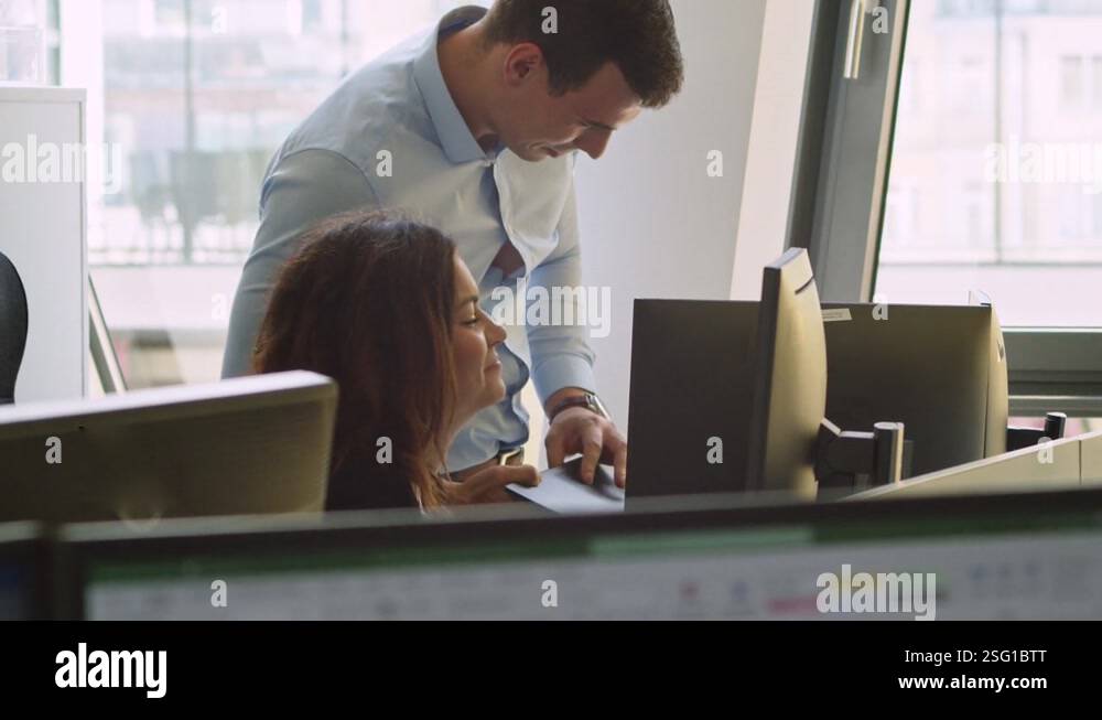 Cool atmosphere in the office. A young businessman advises a colleague ...