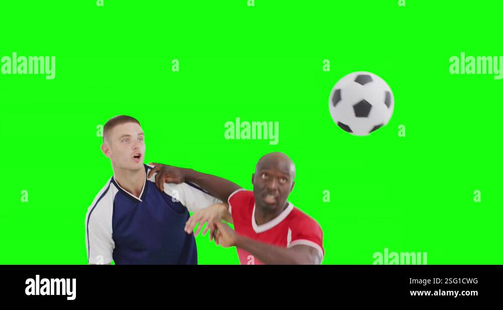 Video of two diverse male soccer players head kicking ball on green ...