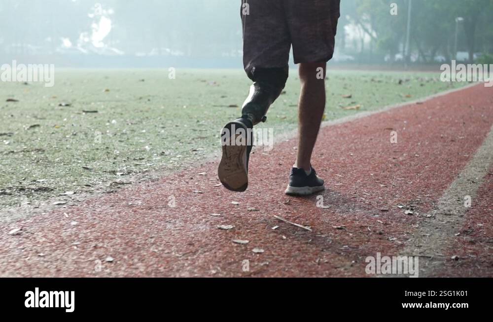 Amputee athlete running with prosthetic leg. Disabled runner with ...