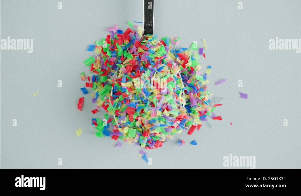 Microplastic pollution, plastic particles in spoon close-up, garbage ...