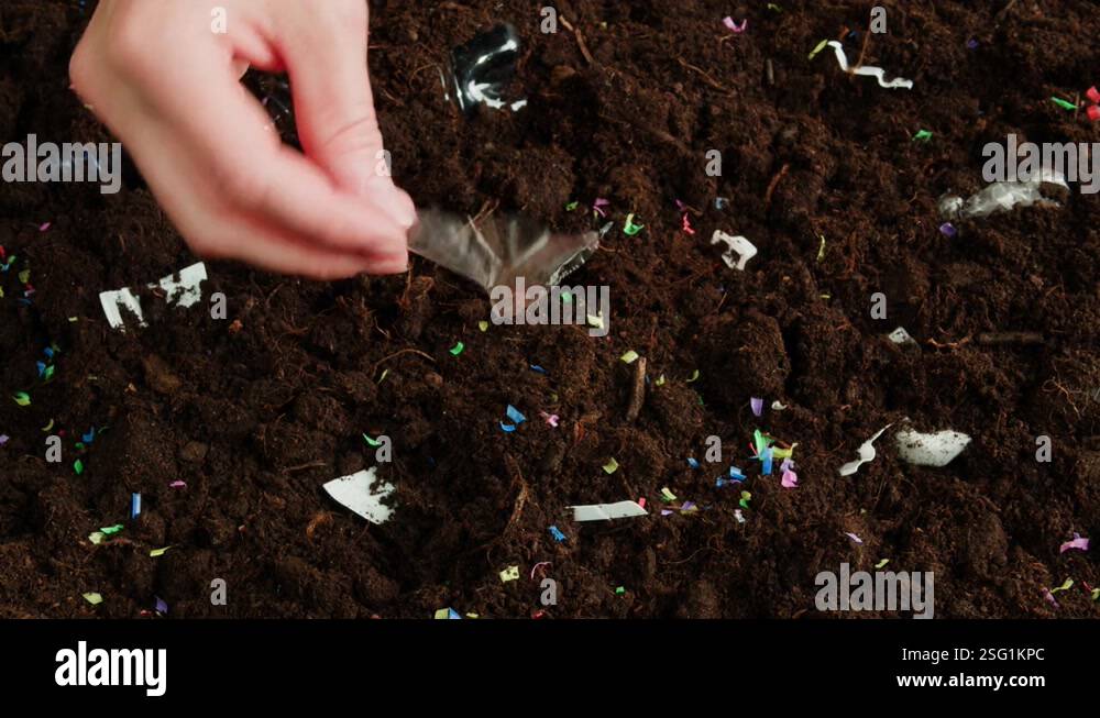 Microplastic earth pollution, plastic particles in soil close-up ...