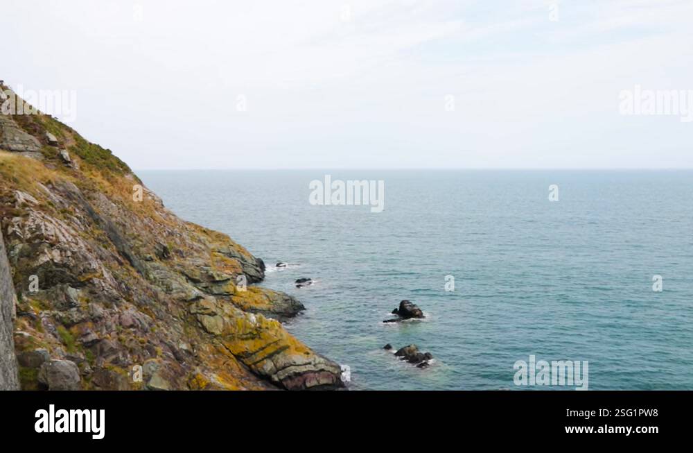 The beautiful grass-covered cliffs of Bray with a clam blue sea. Bray ...
