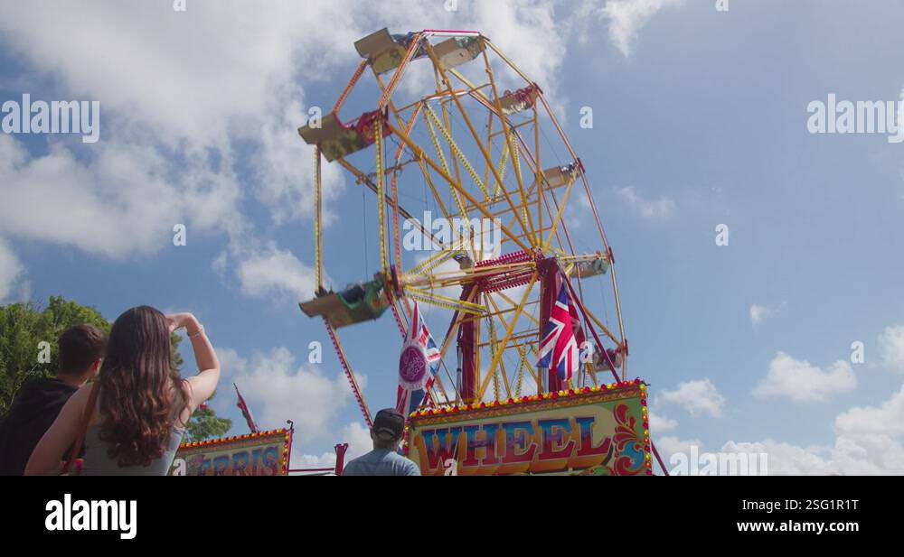 People Enjoy Thrill of Ferris Wheel at Fairground for the Royal ...