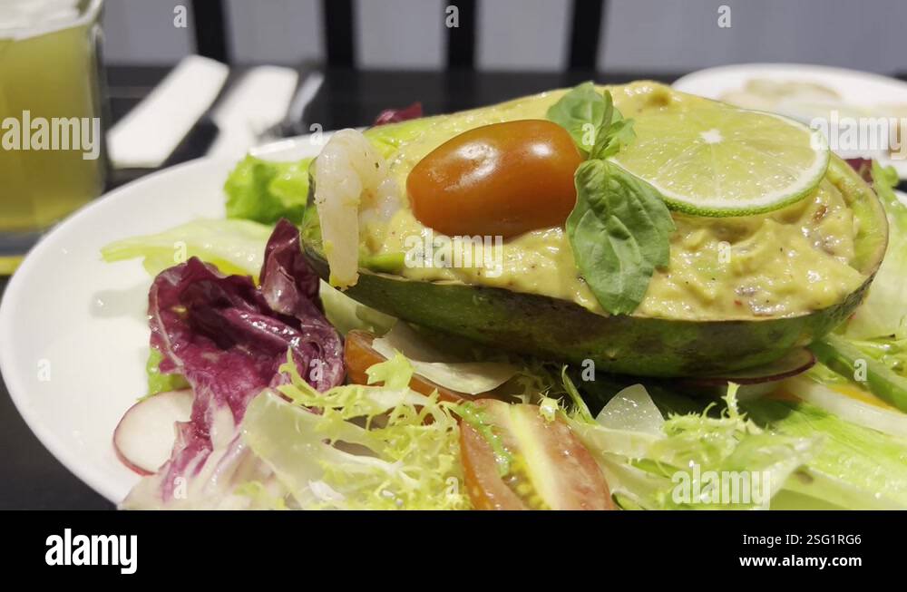 Presentation of Stuffed avocado with shrimps in lemonese cocktail sauce ...