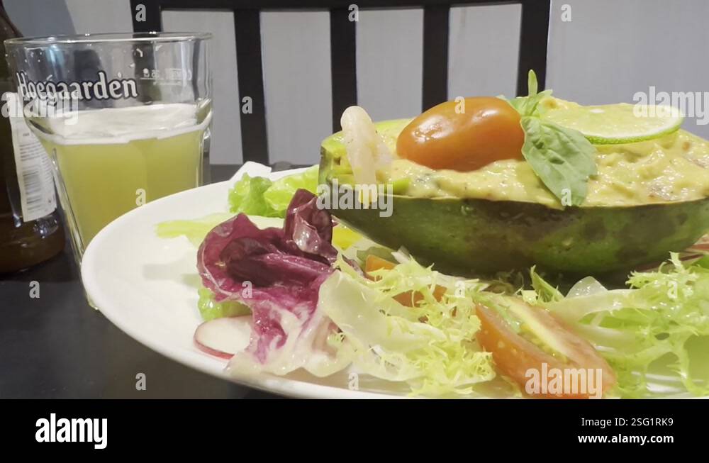 Presentation of Stuffed avocado with shrimps in lemonese cocktail sauce ...