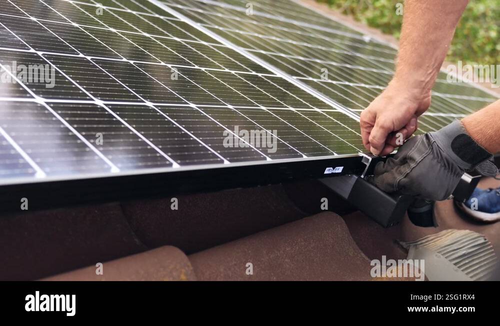 Engineer fixing solar panel cells on rooftop with his hands, close up ...