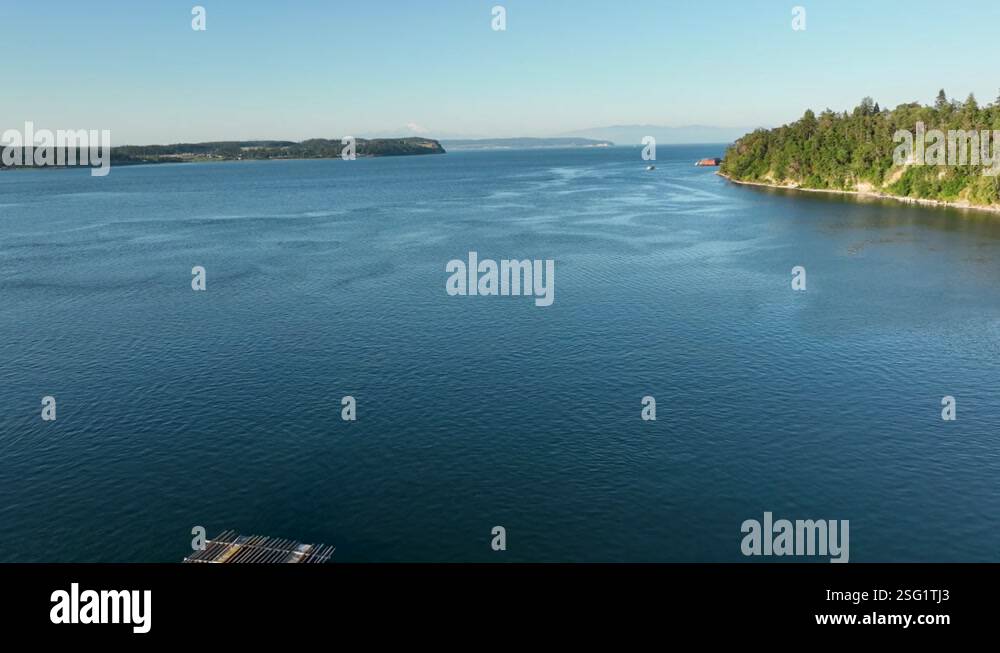 Aerial shot leaving the Penn Cove mussel farm docks and flying out into ...