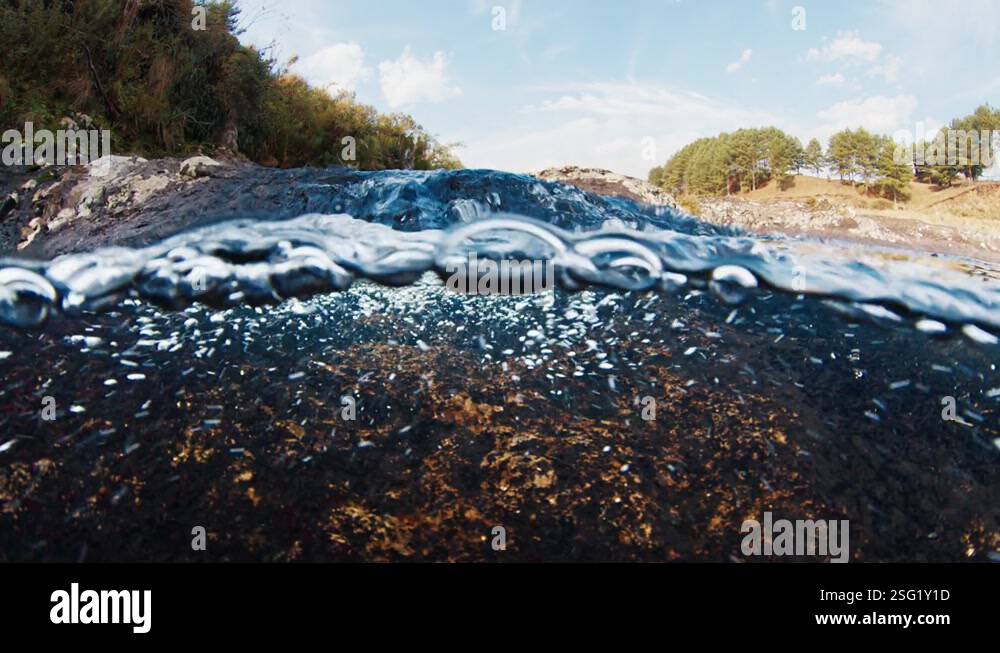 Rapid river split. Splitted view of the clean rapid river flowing in ...
