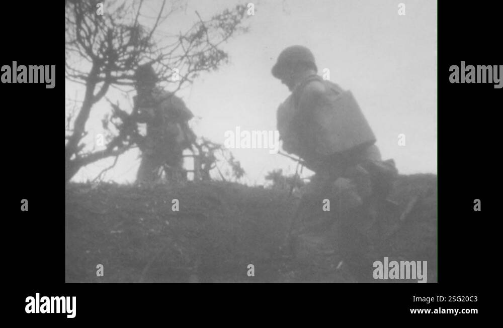 1940s: Soldiers run up hill with guns. Soldiers shoot. Wounded soldier ...
