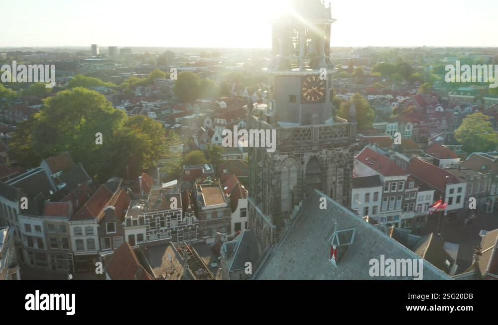 Sunlight Through Clock Tower Of Sint Janskerk With Old City Hall In ...