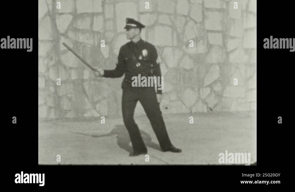1940s: Police officer demonstrates on guard position with baton. Police ...
