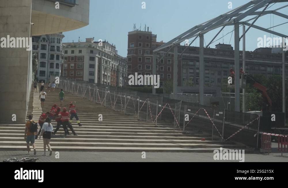 construction workers pulling ropes to erect steel construction for a ...