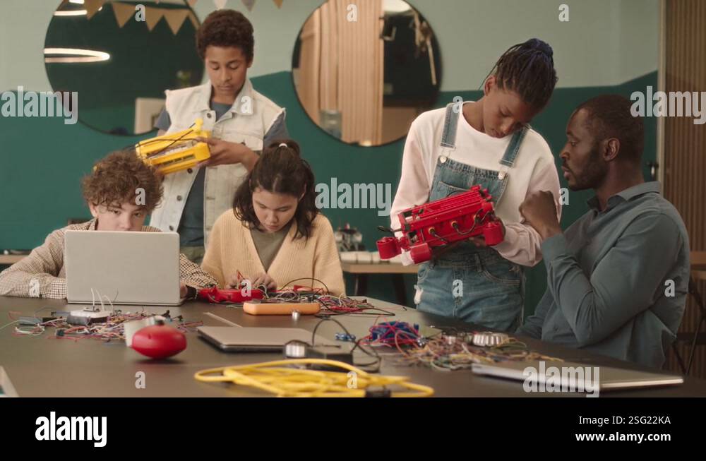 School Kids and Teacher Constructing Robots in Classroom Stock Video ...