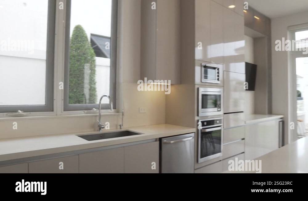 Luxury cozy dining room and kitchen of modern villa, gimbal motion view ...