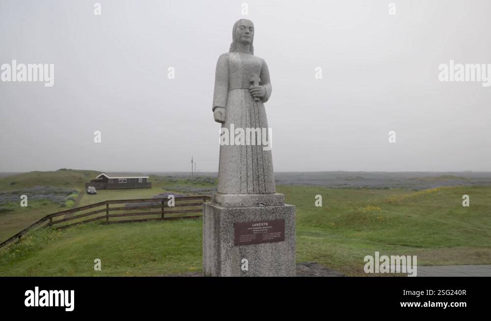 Strandarkirkja church in Iceland pan from statue to church in slow ...