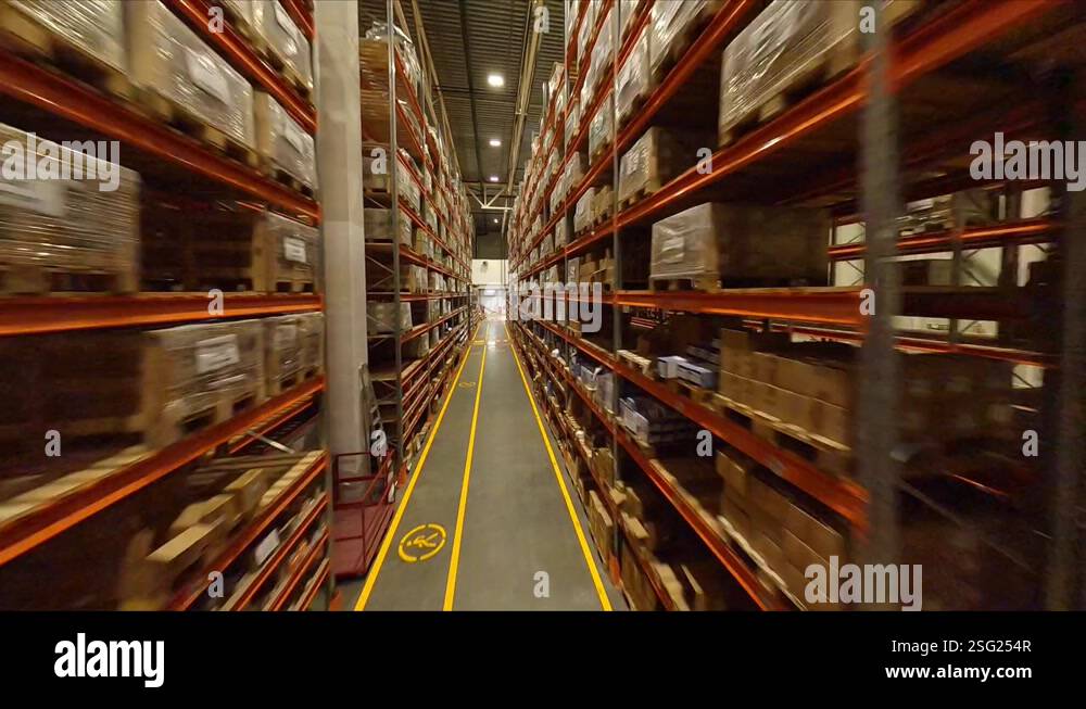 Motion through aisle between high racks with product boxes Stock Video ...