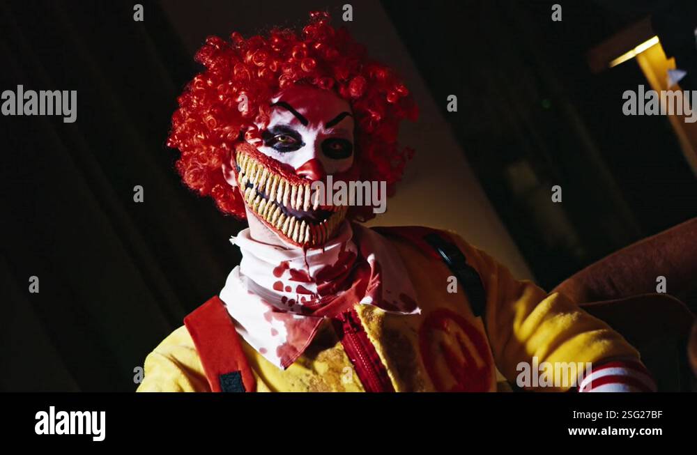 Scary bloody clown mask with big teeth and red hair at Halloween party ...