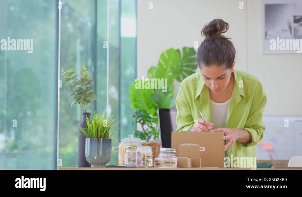 Woman Running Online Business From Home Packing Boutique Candles For ...