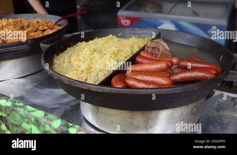 Cooking in a large cauldron dishes. Delicious food cooked over an open ...