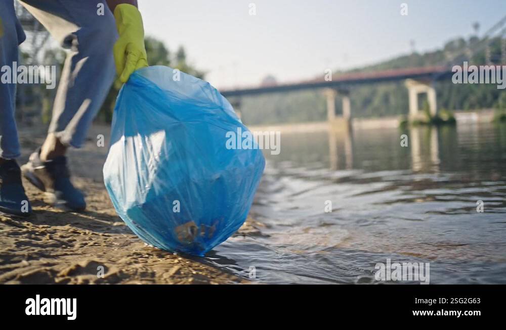 Volunteer catches trash bag discovering plastic inside Stock Video ...