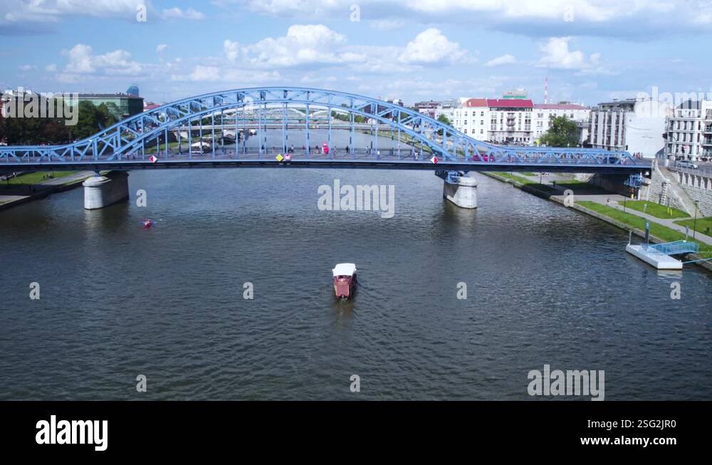 Blue metal arch bridge over Vistula river in Krakow, Poland, aerial ...