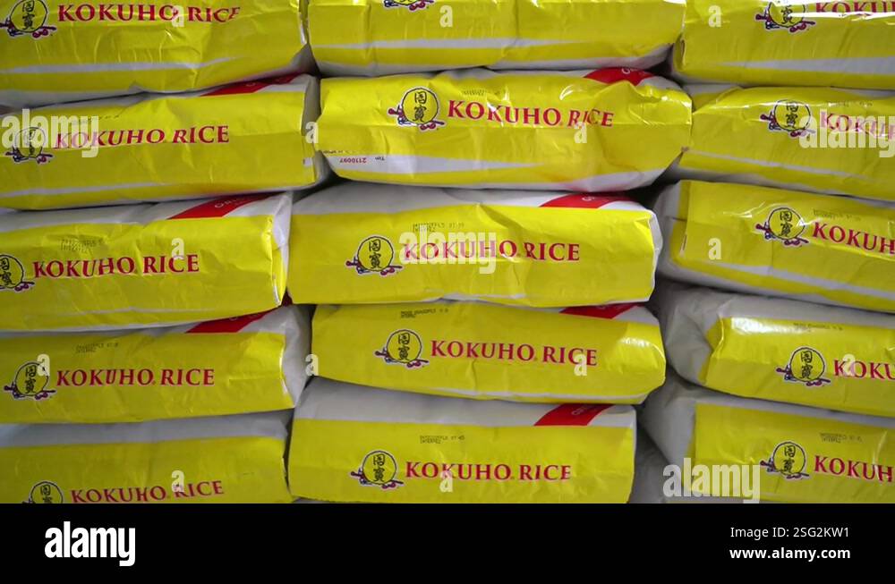 stacks of kukuho rice brand rice bags in a store showing the staple ...