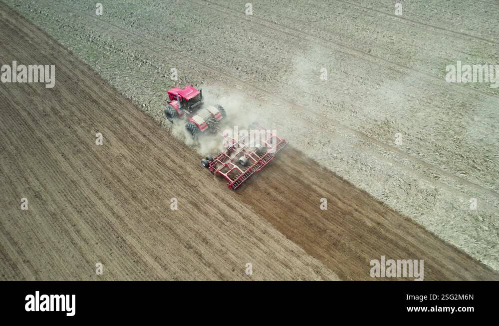 Countryside and agriculture, farm tractor plow the earth in field, dust ...