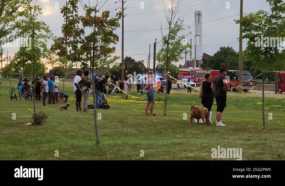 People gather in the neighborhood looking at a fire accident site Stock ...