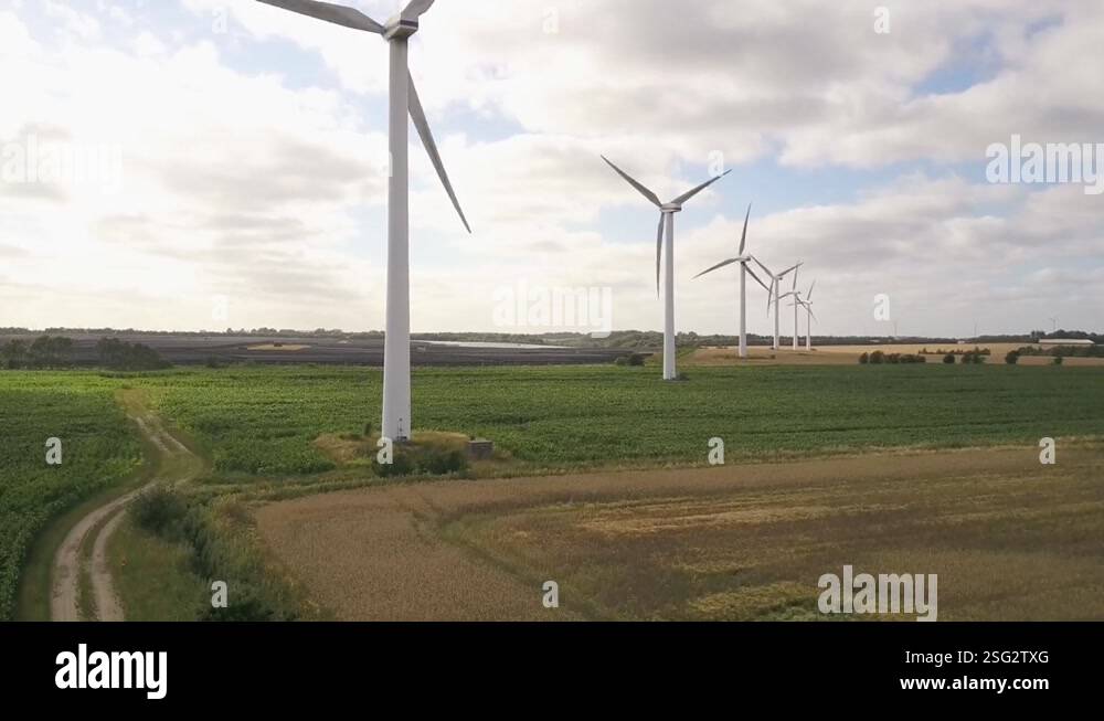 Row Of Wind Turbines Generating Electricity On Wind Farm. Renewable ...
