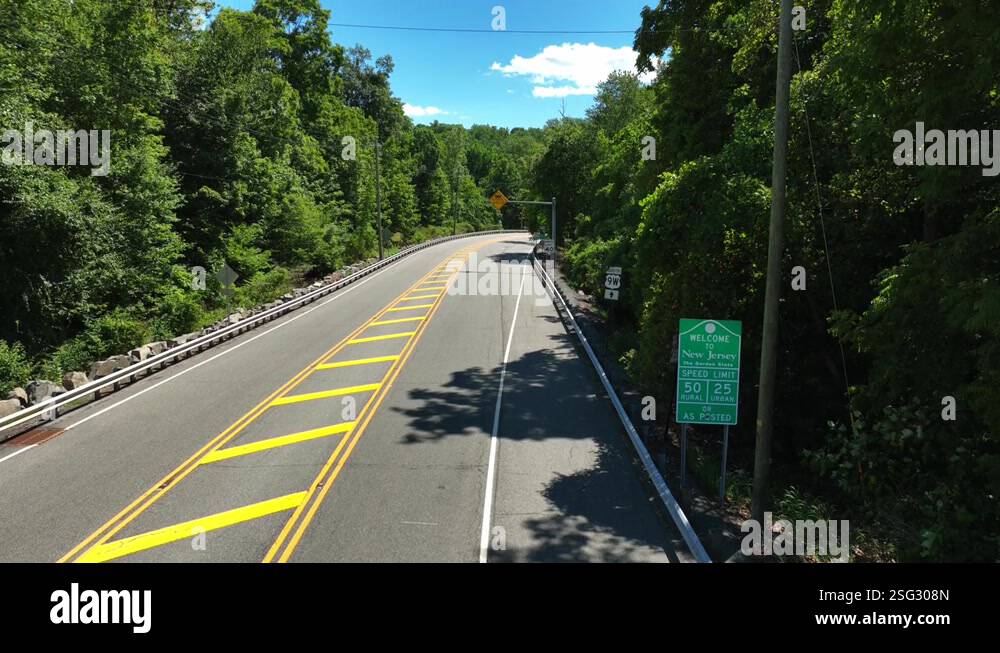 Welcome to New Jersey. State border on summer day on quiet country road ...